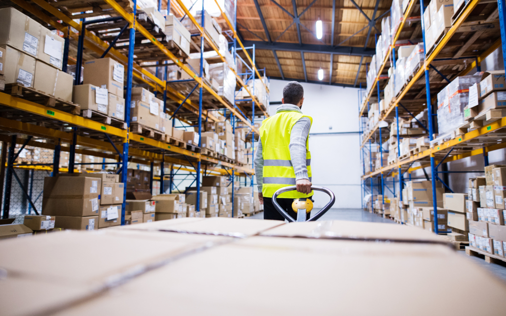 Man Dragging Pile of Boxes in Warehouse - A&M Construction Services
